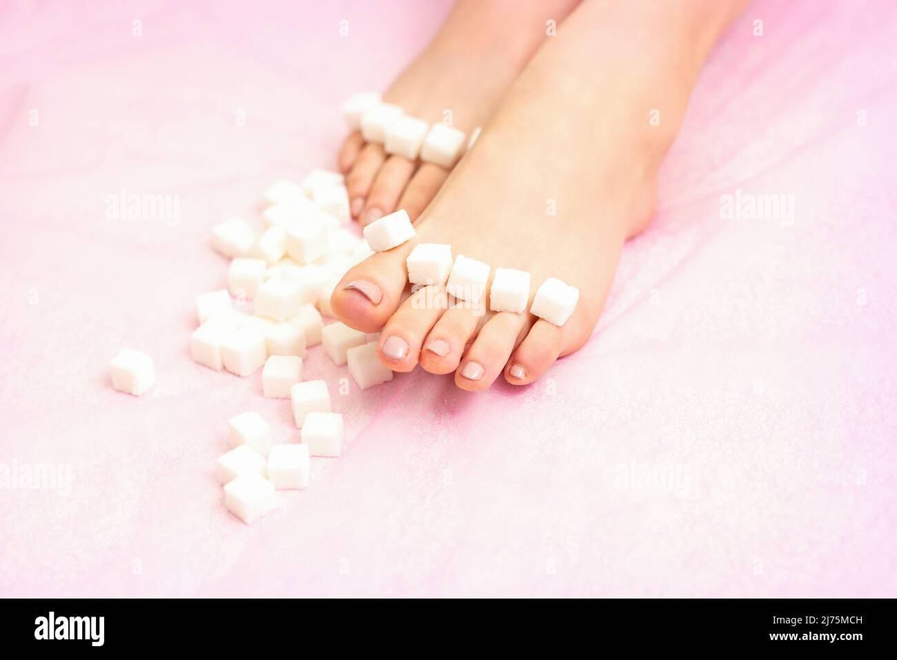 The concept of epilation, waxing. Sugar cubes lying down in a row on ...