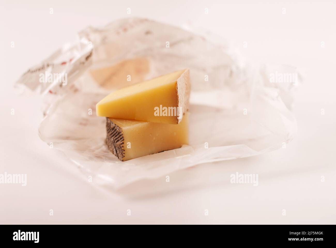 Two Small Wedges of Gruyere on Paper Stock Photo - Alamy