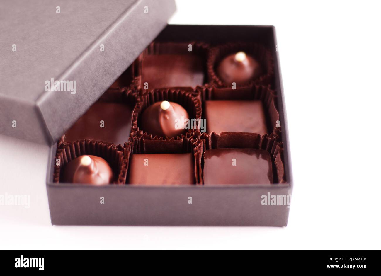 Open box of gourmet caramels Stock Photo - Alamy