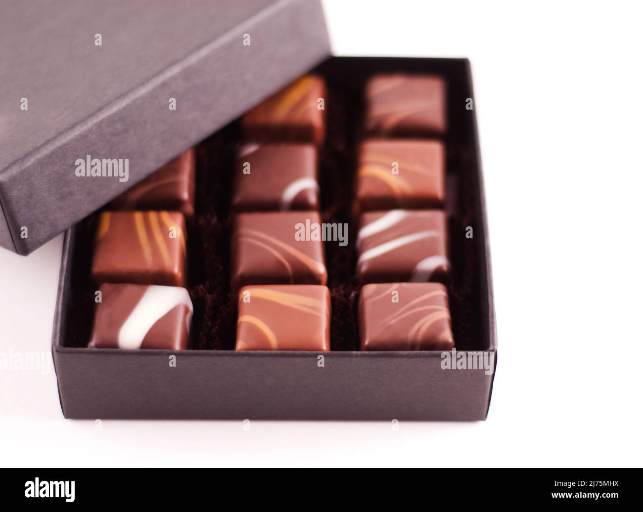 Open box of gourmet caramels Stock Photo - Alamy
