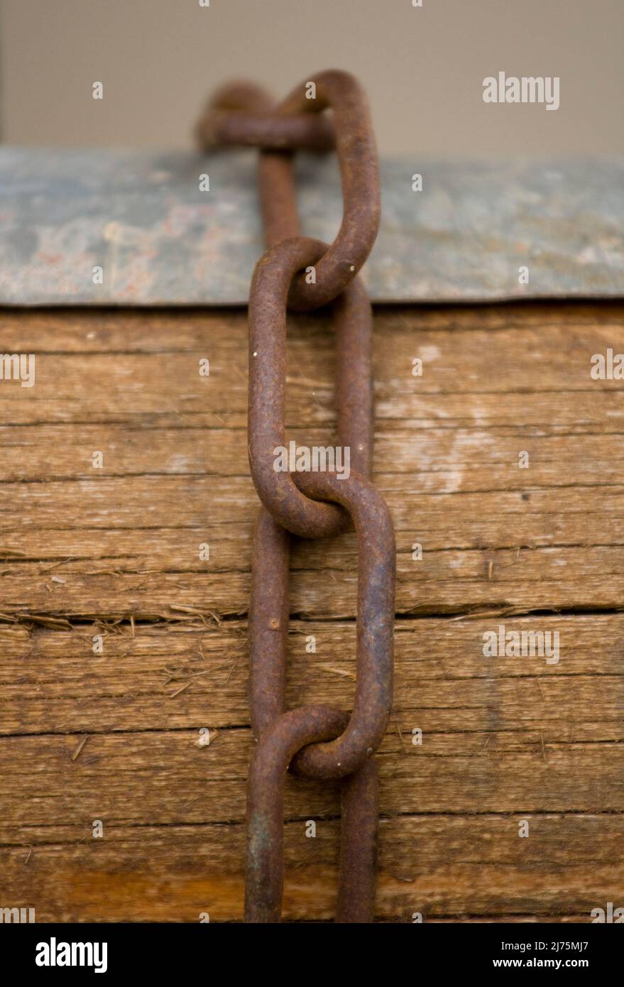 old chain on a wood stick Stock Photo - Alamy
