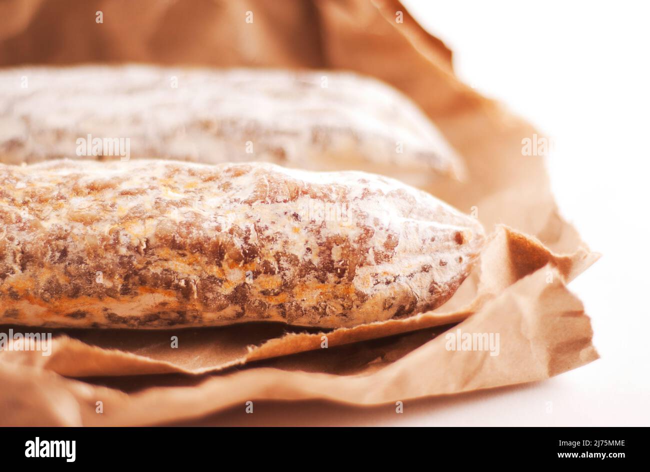 Two Whole Salami on Brown Paper Stock Photo - Alamy