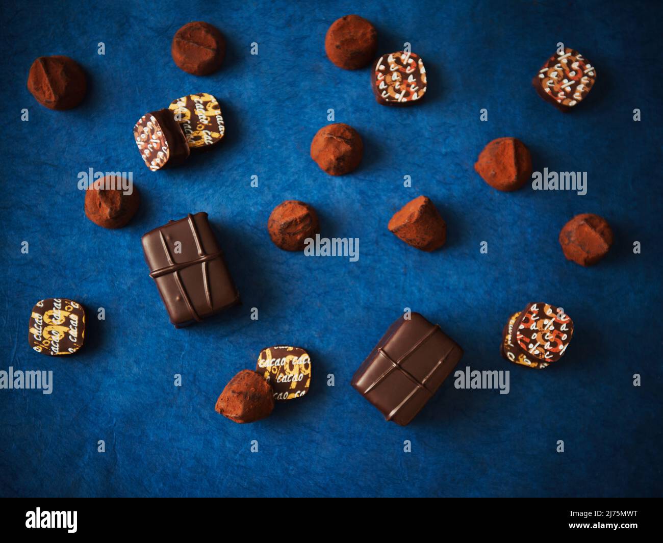 Assorted Chocolates on a Dark Blue Background Stock Photo - Alamy
