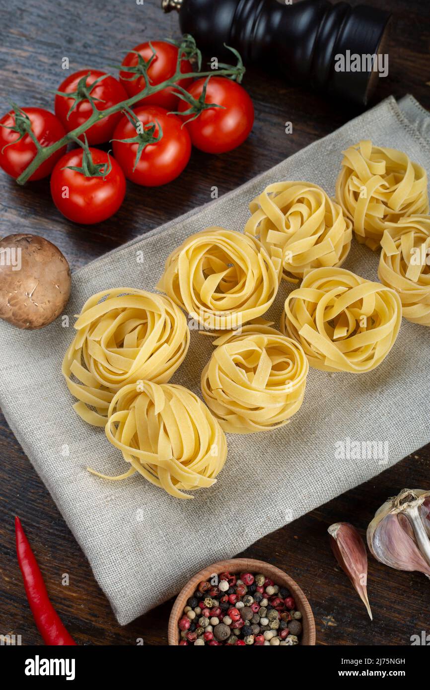 Raw pasta tagliatelle with fresh tomatoes, peppers, asparagus beans ...
