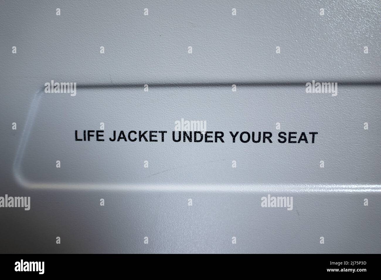 life jacket under your seat airplane sign detail Stock Photo - Alamy