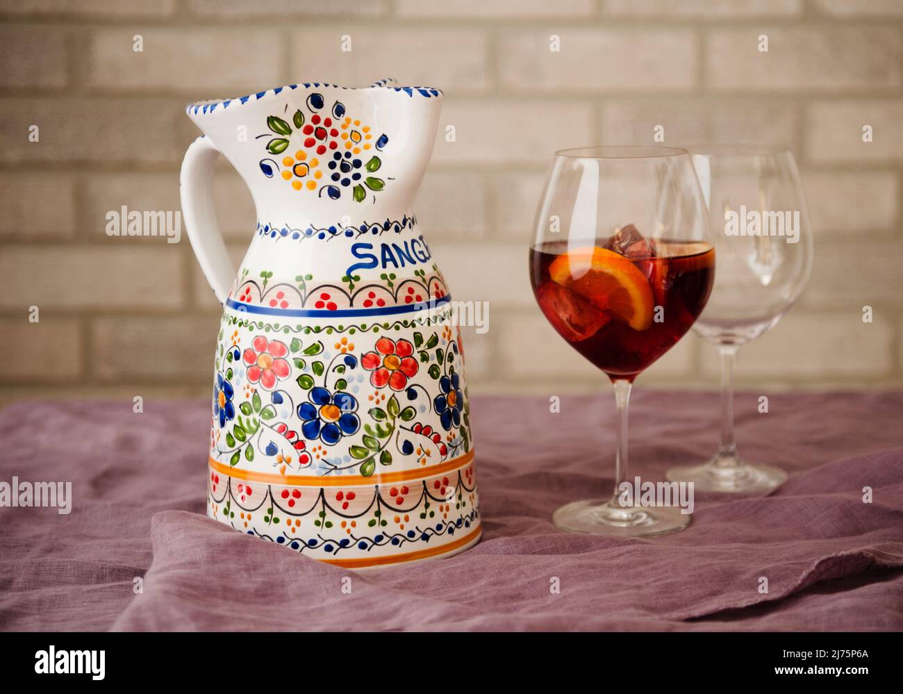 A Sangria Pitcher with a Floral Design with a Glass of Sangria; Empty ...