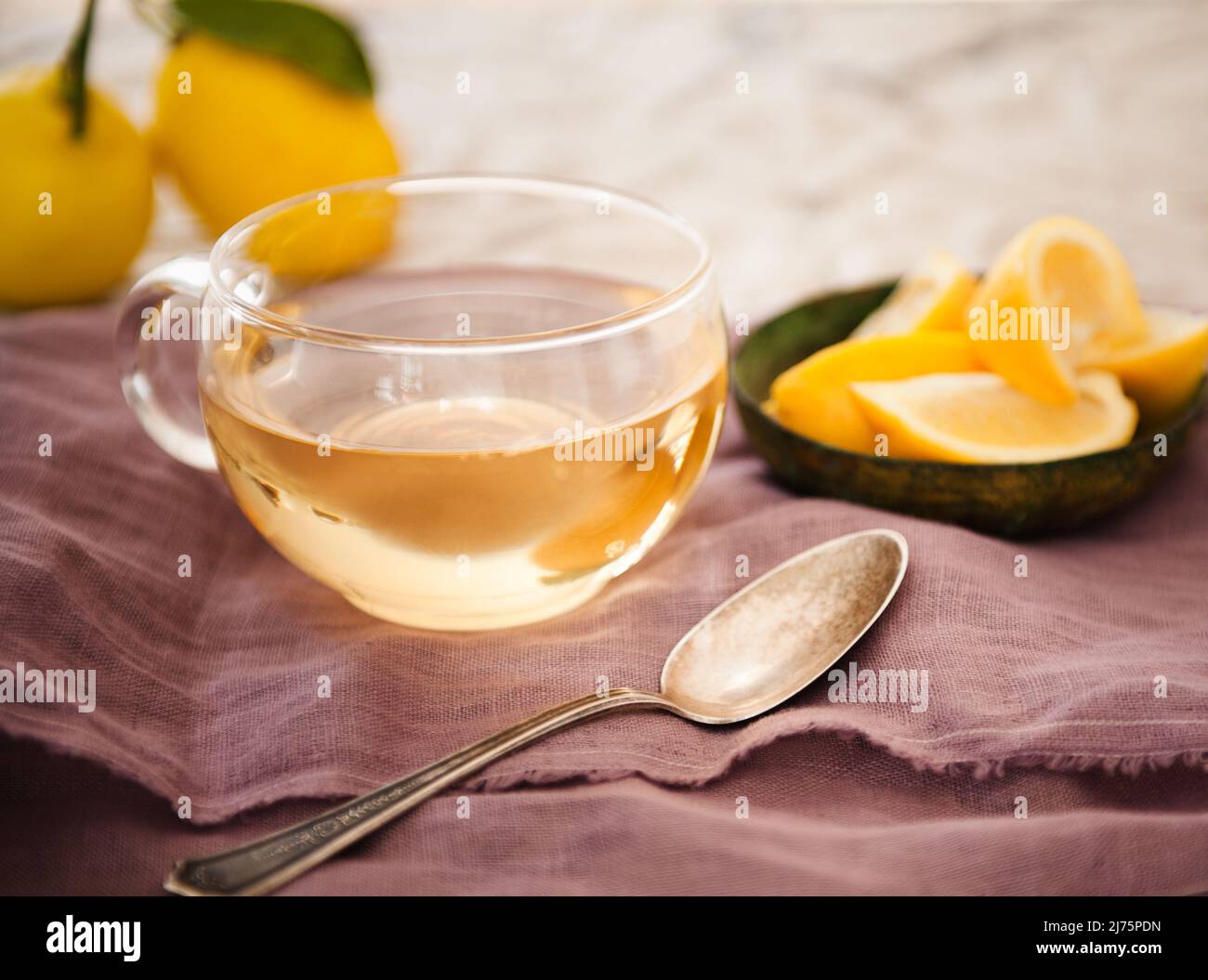Green Tea with Lemon in a Clear Glass Mug Stock Photo - Alamy