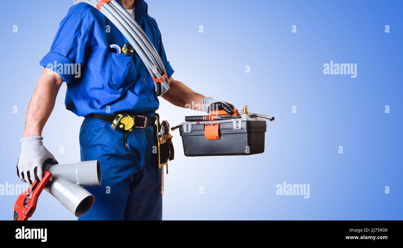 Detail of uniformed plumber with work tools in hands and blue gradient ...