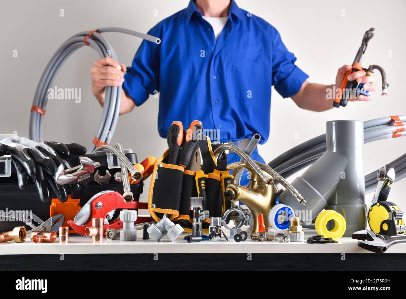 Sample of plumbing materials and tools on workbench and white isolated ...