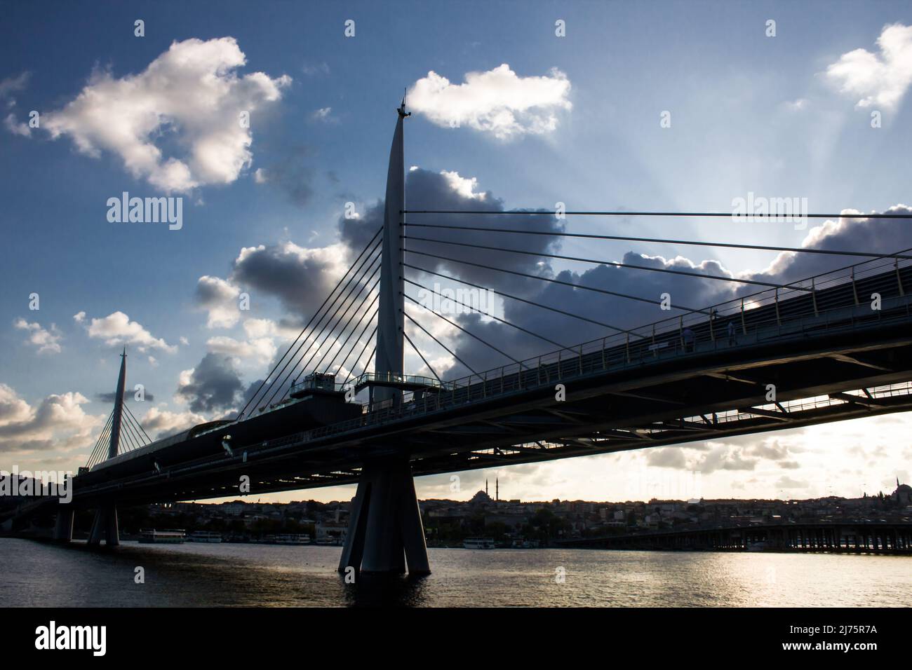 Modern subway bridge in silhouette when sunset time over the estuary in ...
