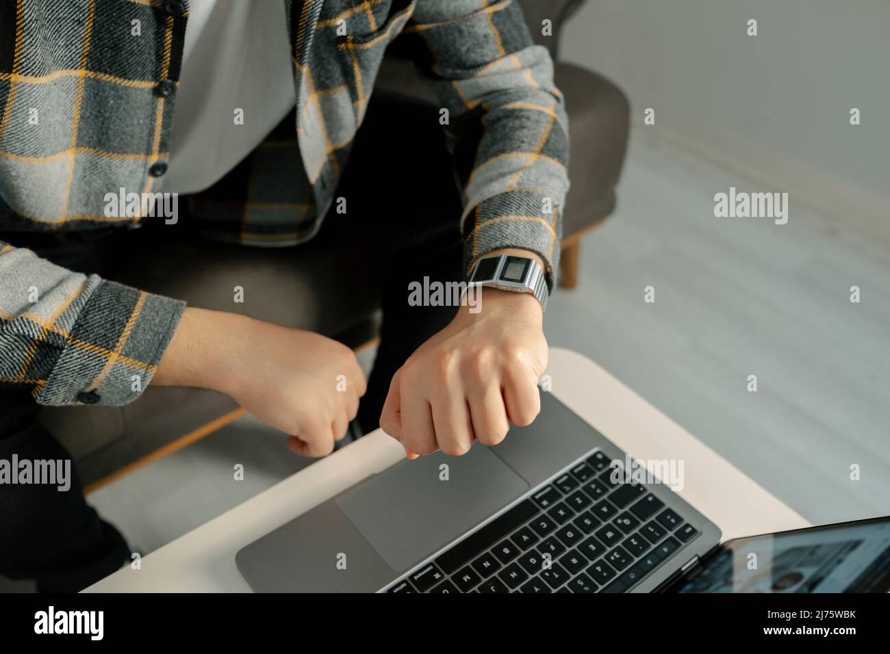 Digital wrist watch, the young man looks at the watch on his wrist, can ...