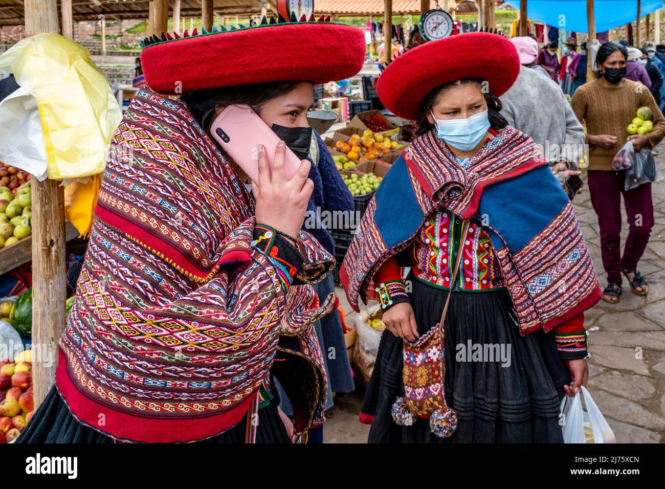 Young Indigenous Quechua Women Using Mobile Phones At The Famous Sunday ...