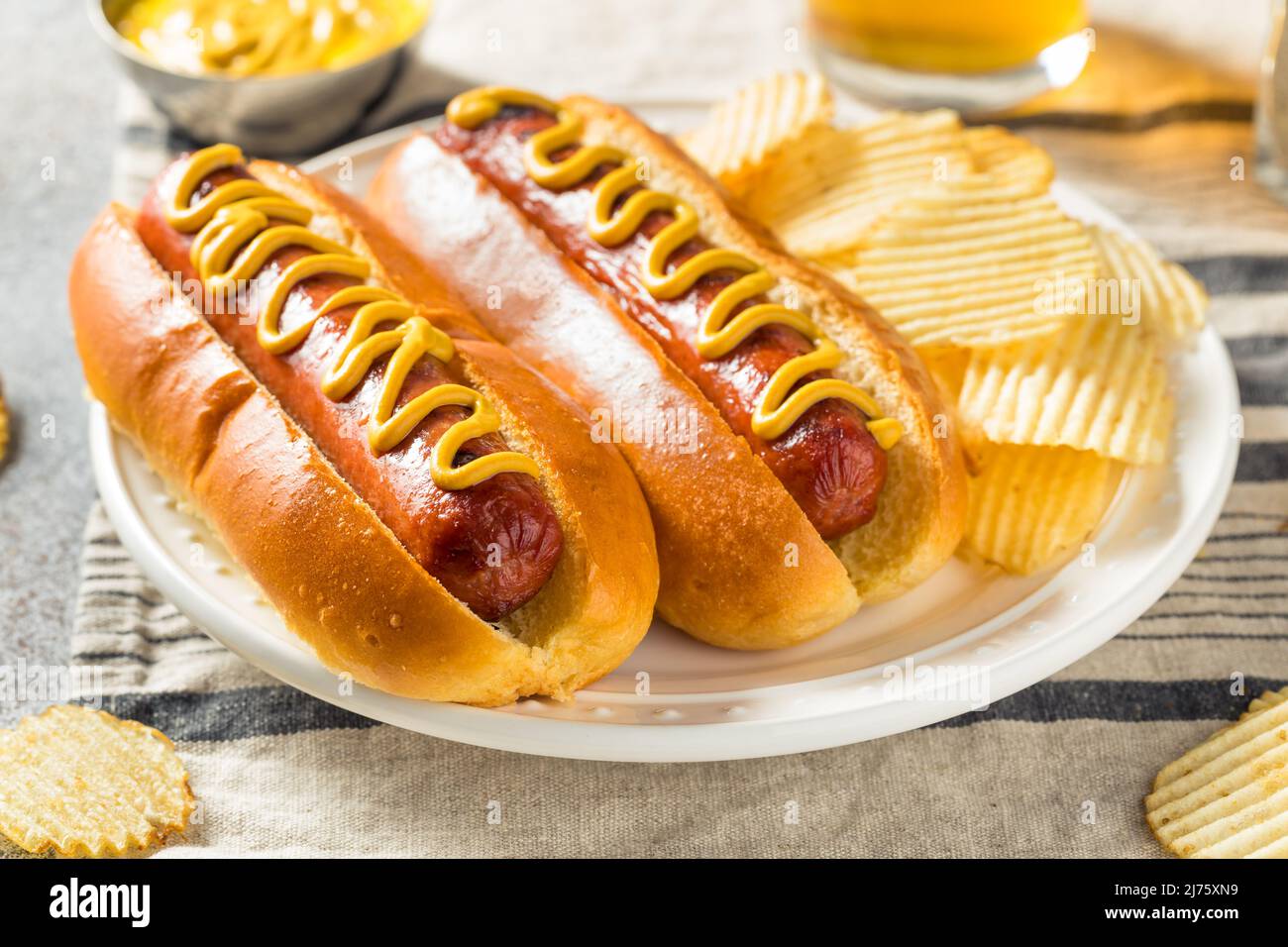 Homemade American Hot Dog with Mustard and Potato Chips Stock Photo - Alamy