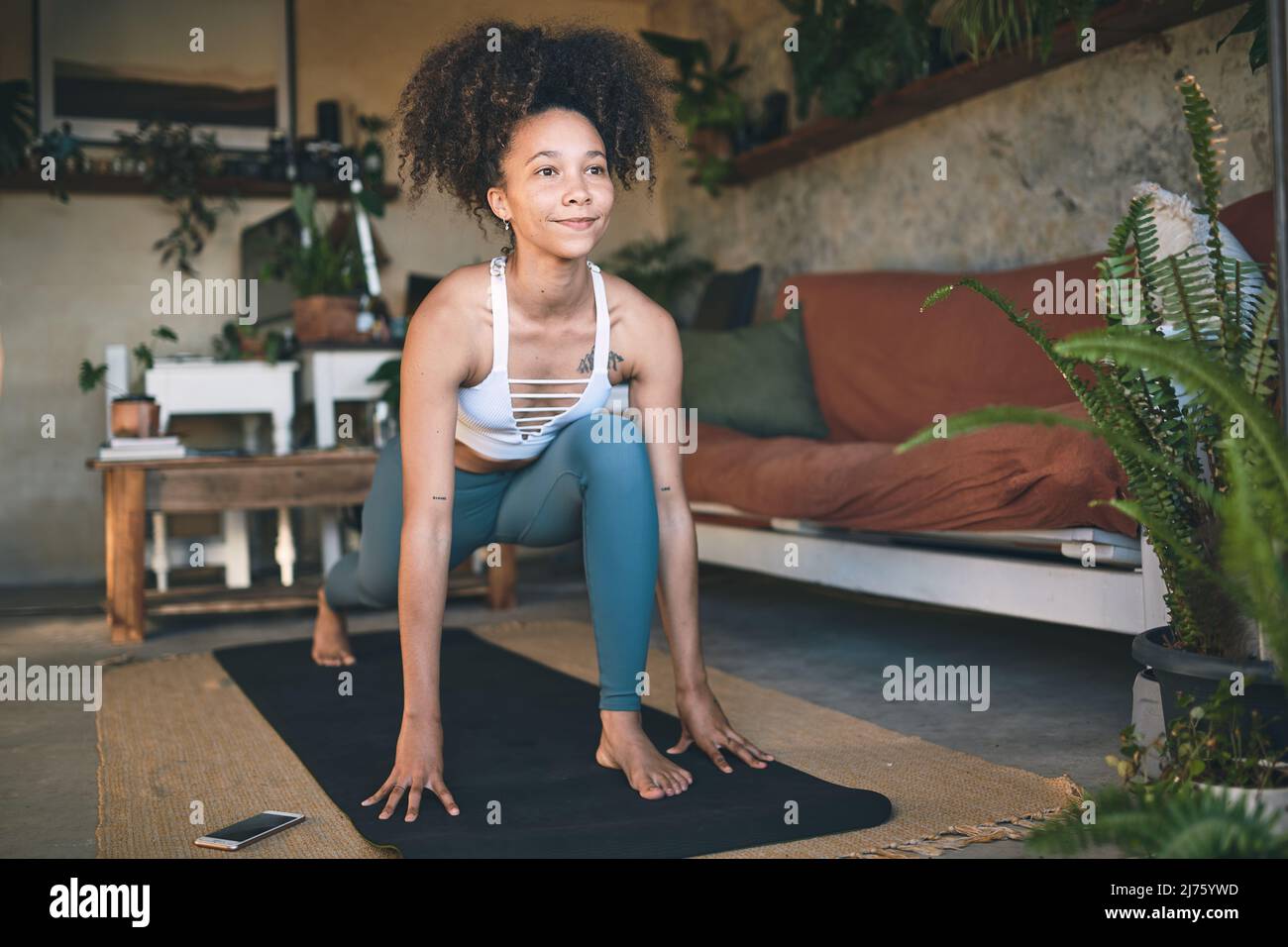 Improving her flexibility and strength with every stretch Stock Photo ...