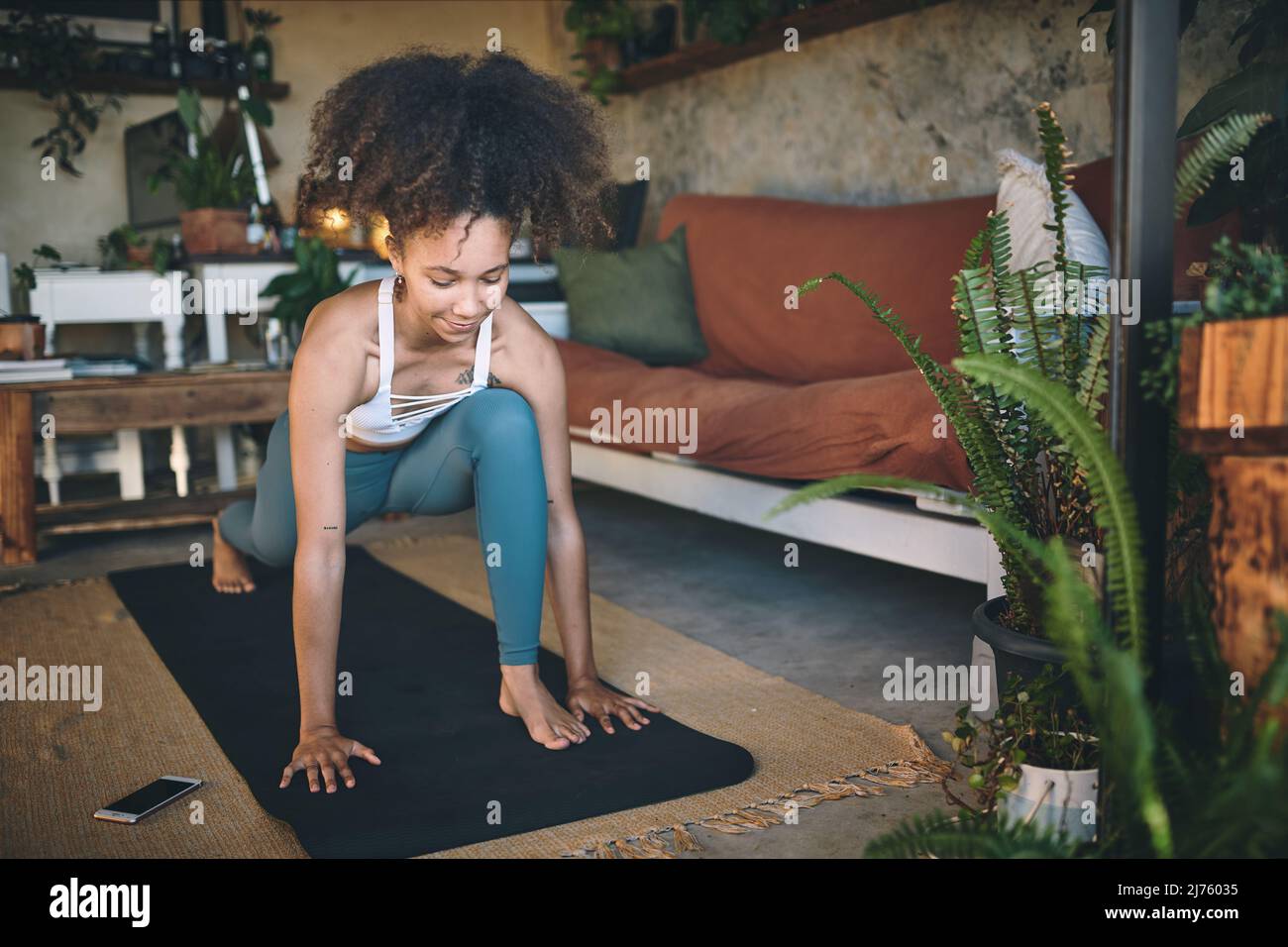 Improving her flexibility and strength with every stretch Stock Photo ...