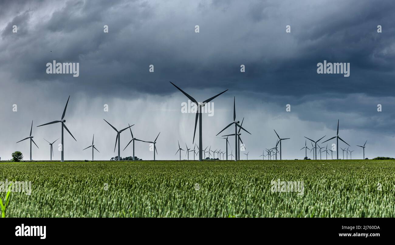 Wind turbines during storm in a green field Stock Photo - Alamy