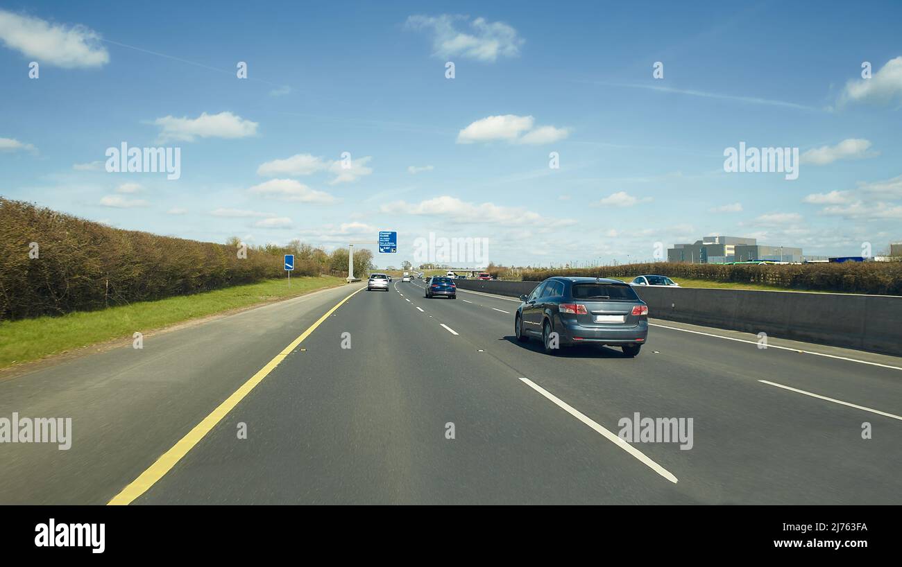 Rear view of cars driving on motorway, Ireland. Road with metal safety ...
