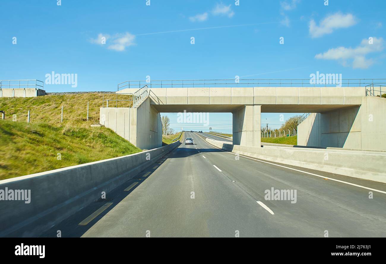 Rear view of cars driving on motorway, Ireland. Road with metal safety ...