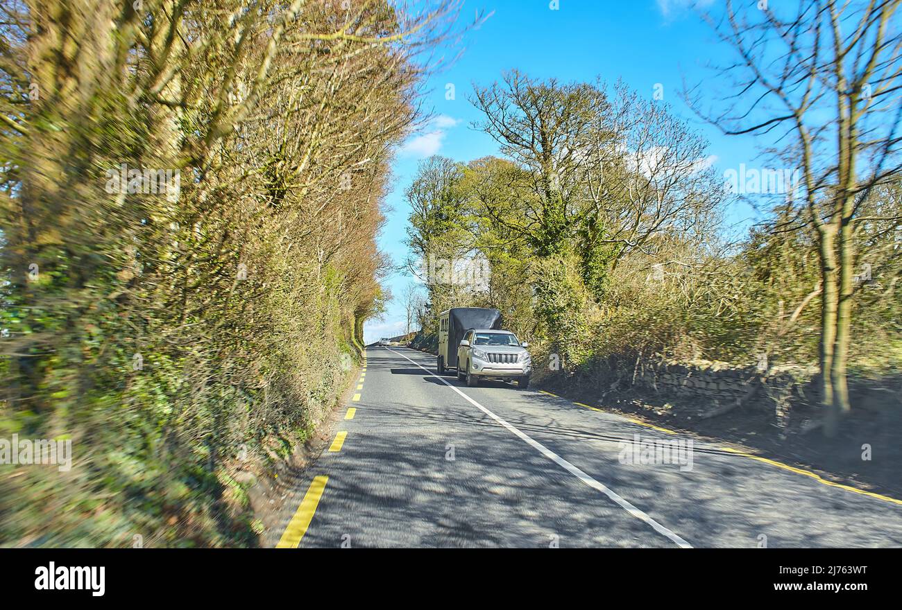 Rear view of cars driving on motorway, Ireland. Road with metal safety ...