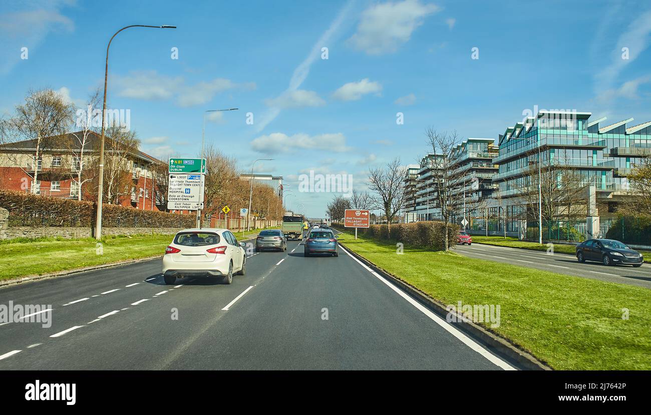 Rear view of cars driving on motorway, Ireland. Road with metal safety ...