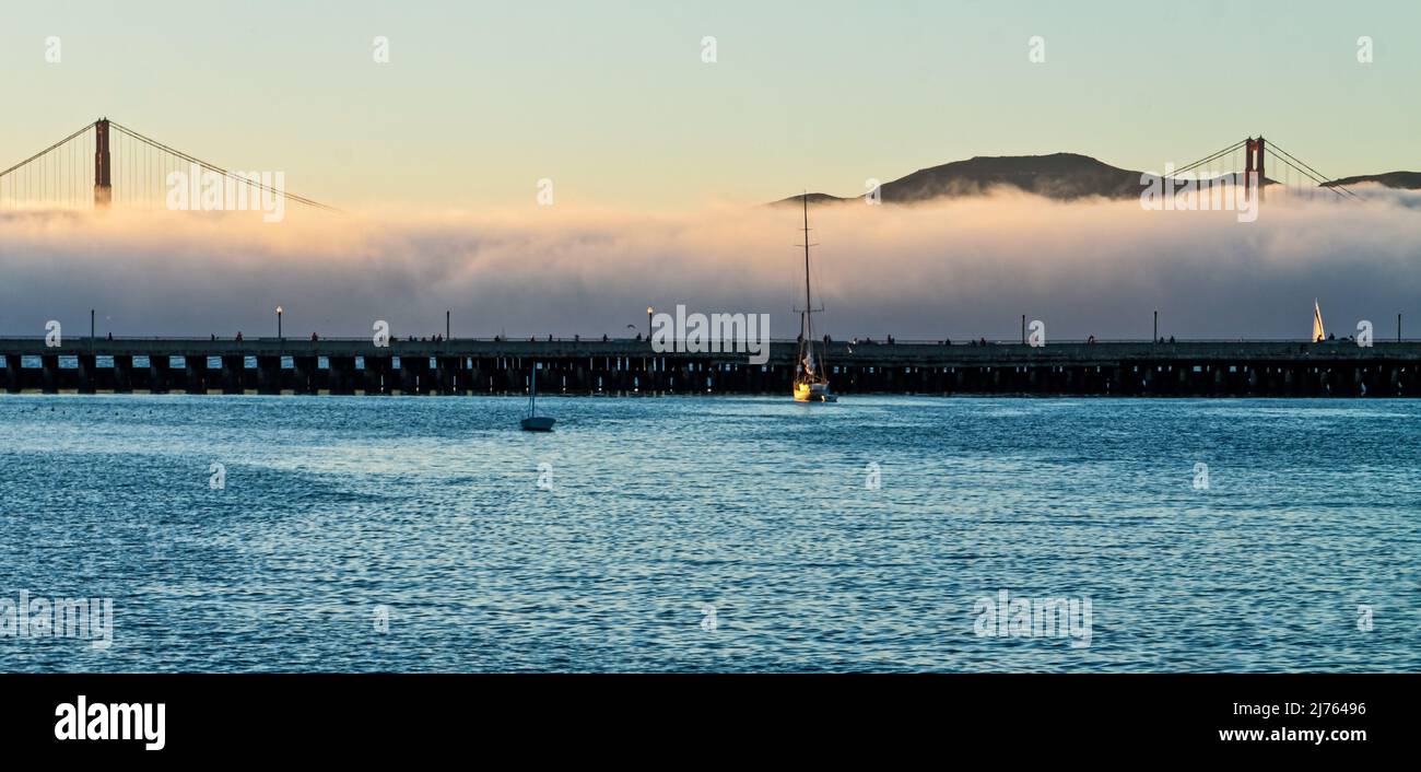 Sailboat Moored Near Municipal Pier With Fog Laden Golden Gate Bridge ...