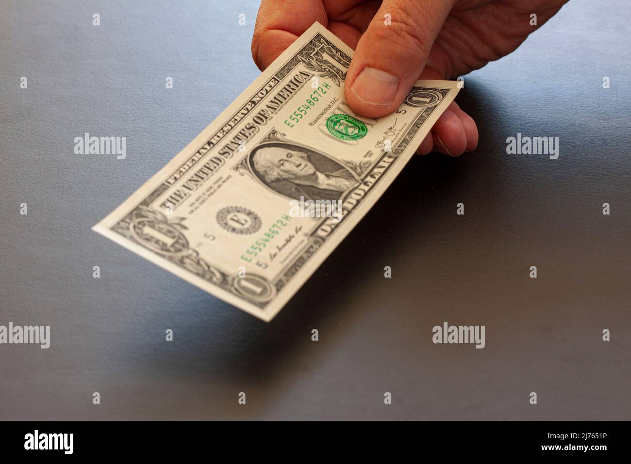 Handing a one dollar bill hi-res stock photography and images - Alamy