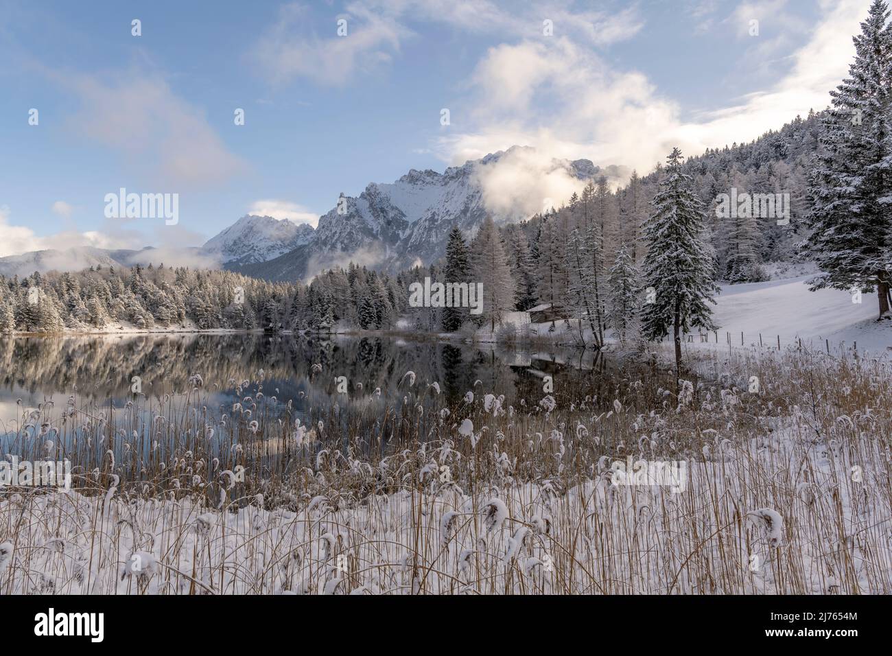 The small Lautersee above Mittenwald in the fresh snow of a beautiful ...