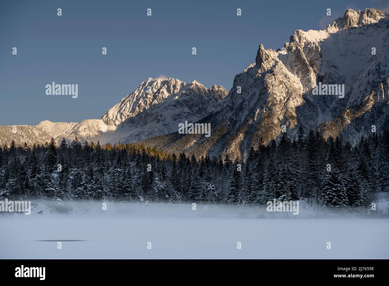 The frozen lautersee with ground fog and snow in winter. In the ...