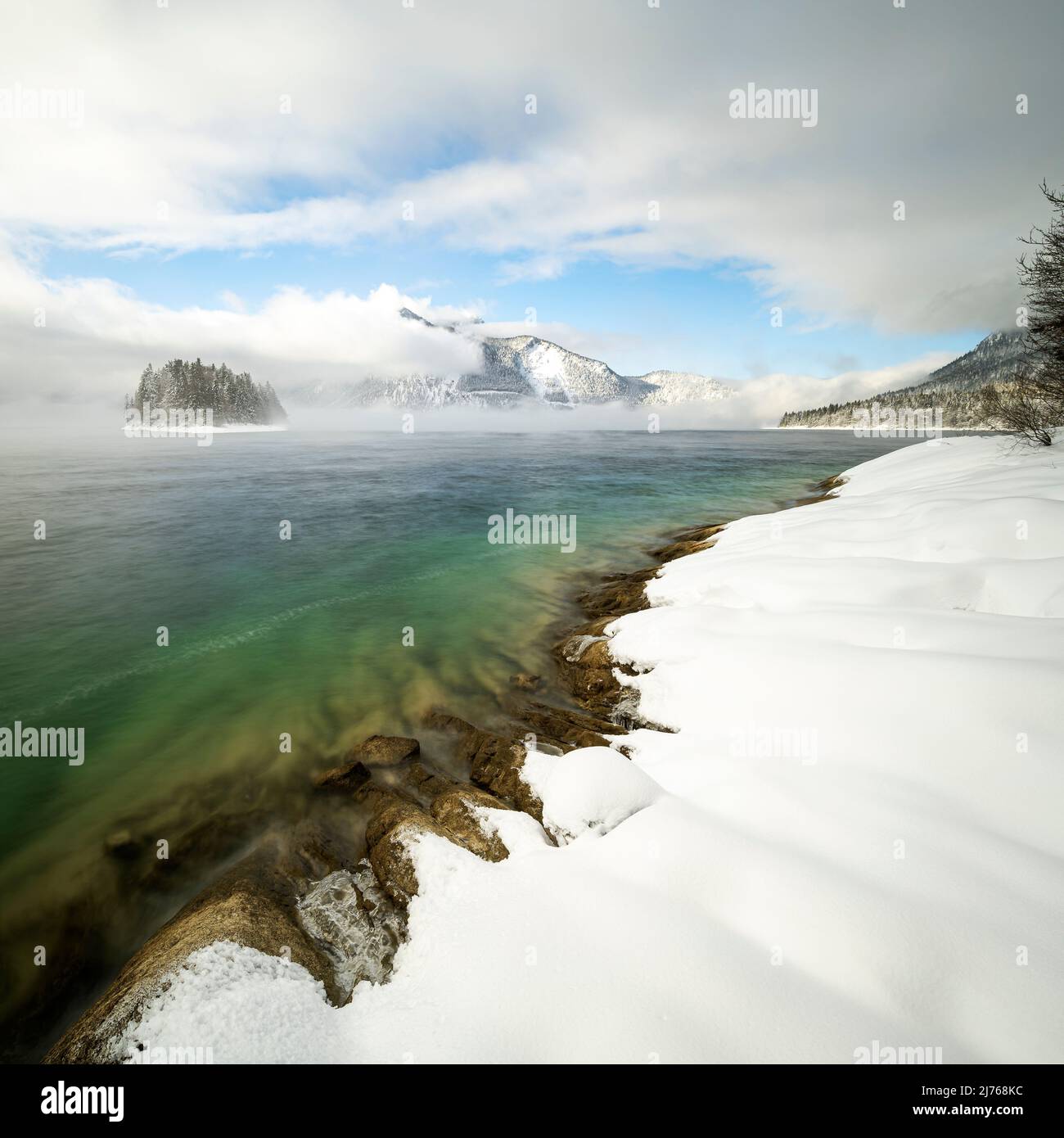 Winter with snow, clouds and fog on the shore of Walchensee, in the ...