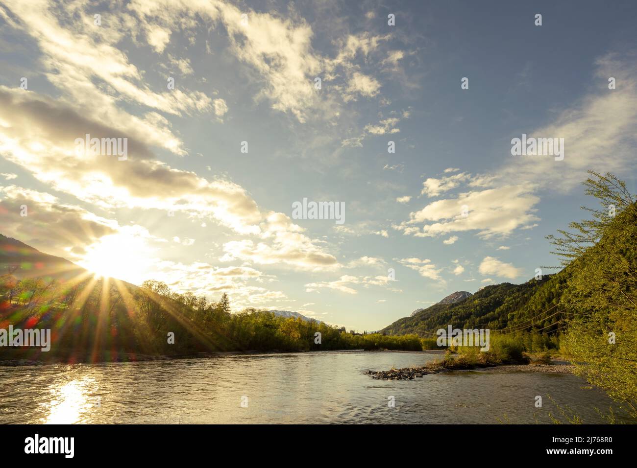 Sunrise with sun star at the river Isel near Lienz in East Tyrol Stock ...