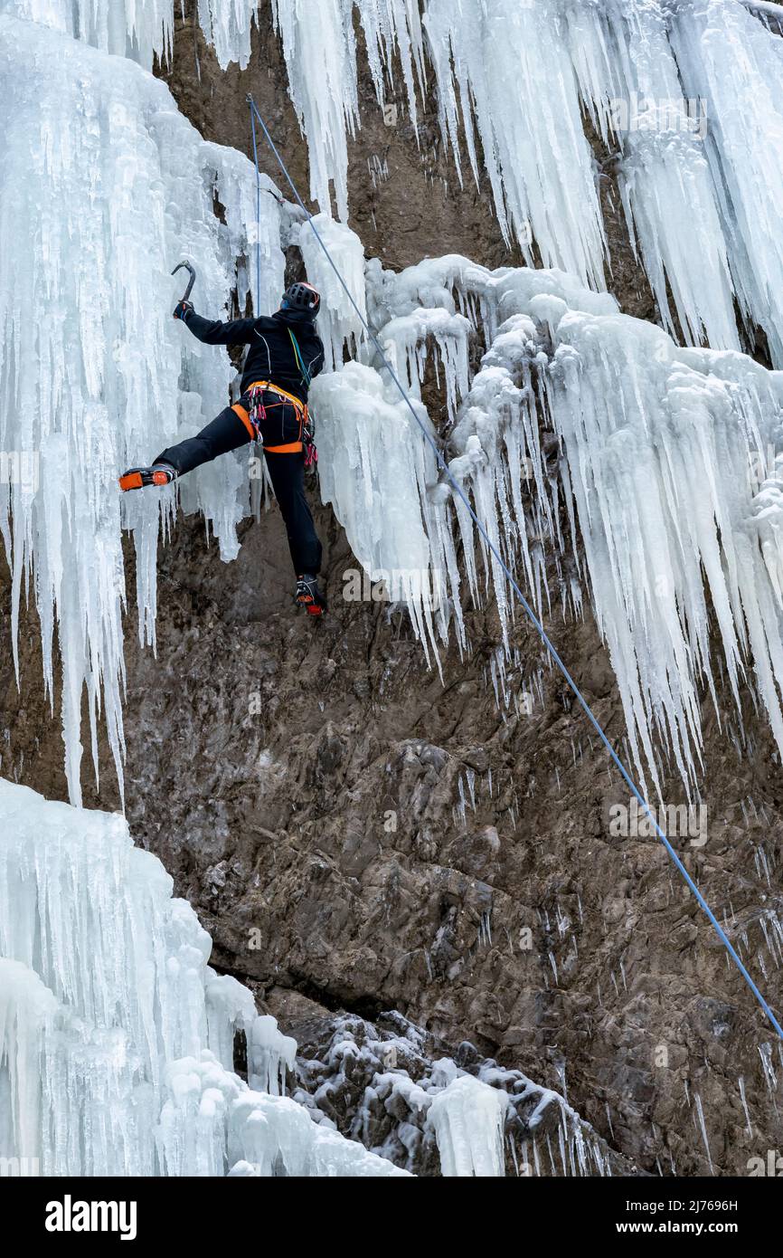 Ice climber at a frozen waterfall Stock Photo - Alamy