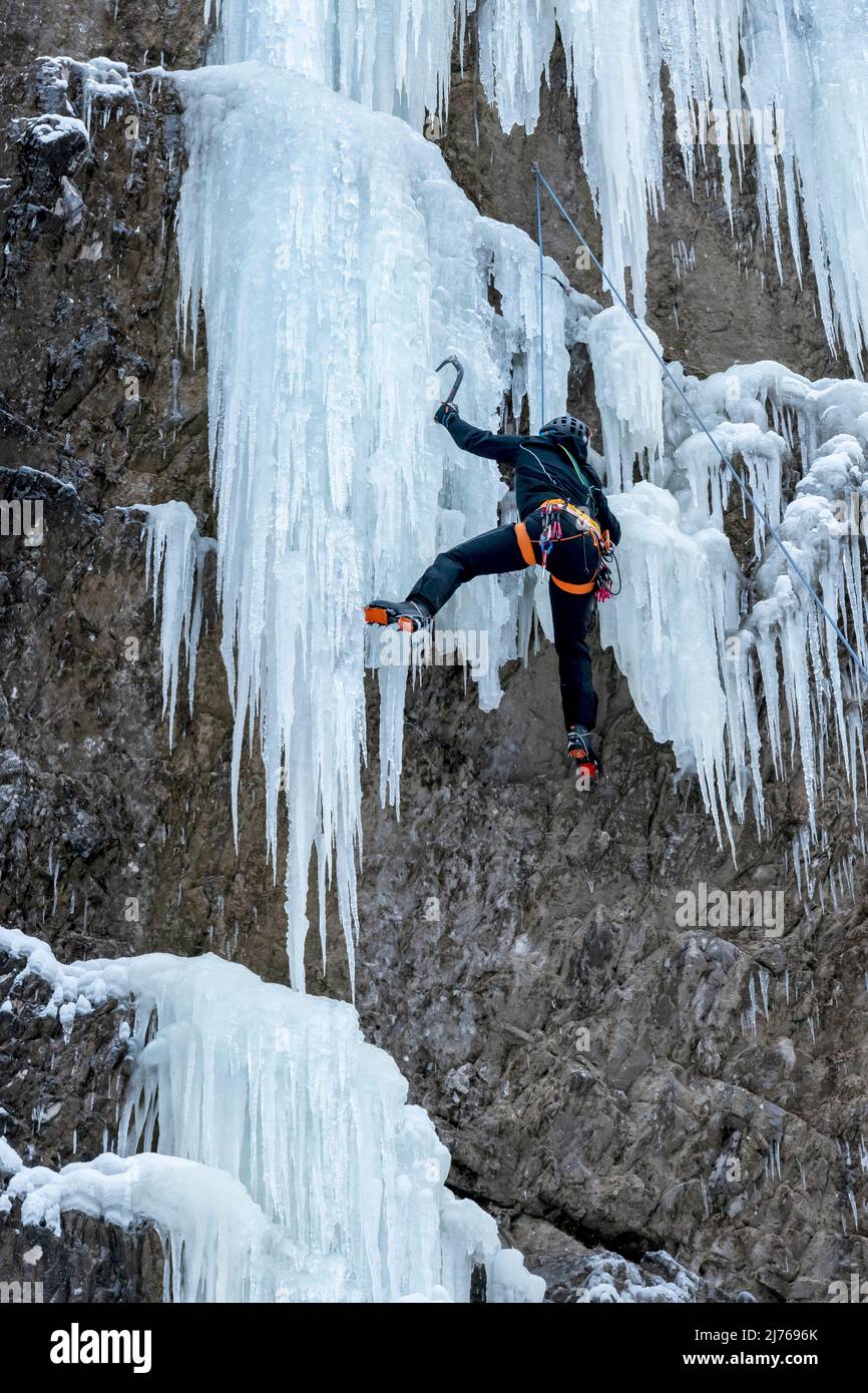 Ice climber at a frozen waterfall Stock Photo - Alamy