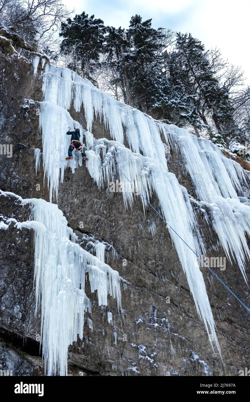 Ice climber at a frozen waterfall Stock Photo - Alamy