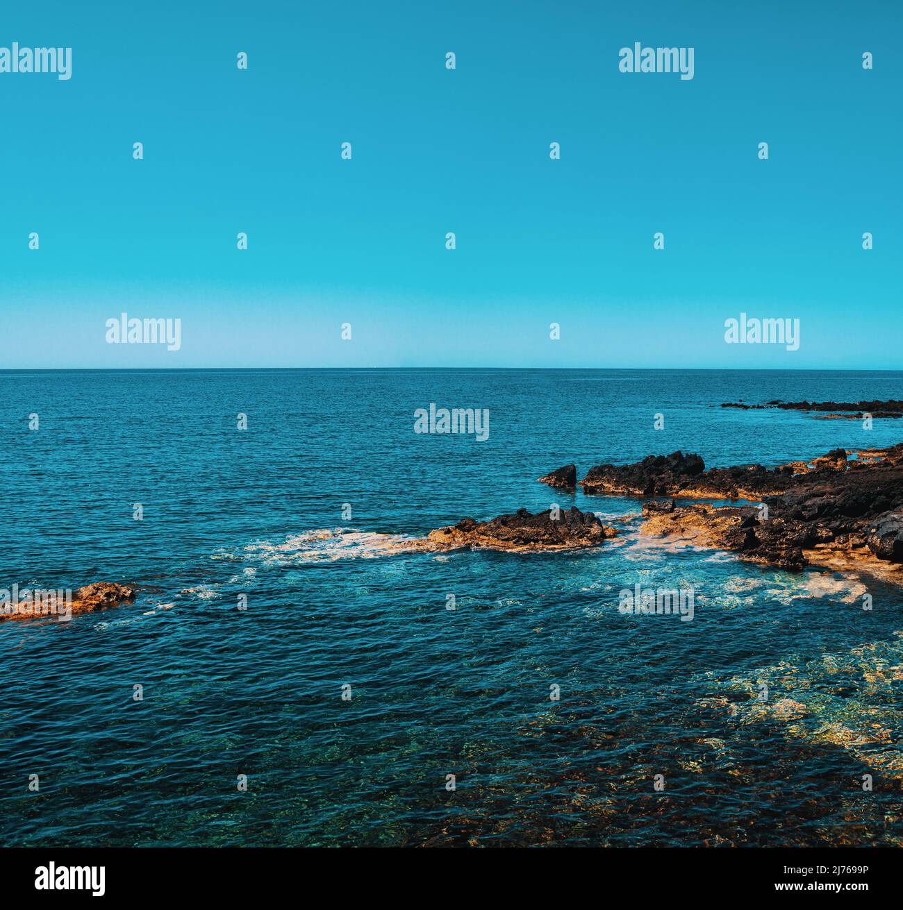 View of the scenic lava rock cliff in the Linosa island. Sicily Stock ...