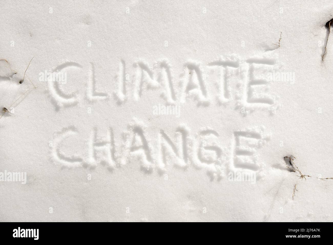 Text "climate change" written on snowy ground Stock Photo - Alamy
