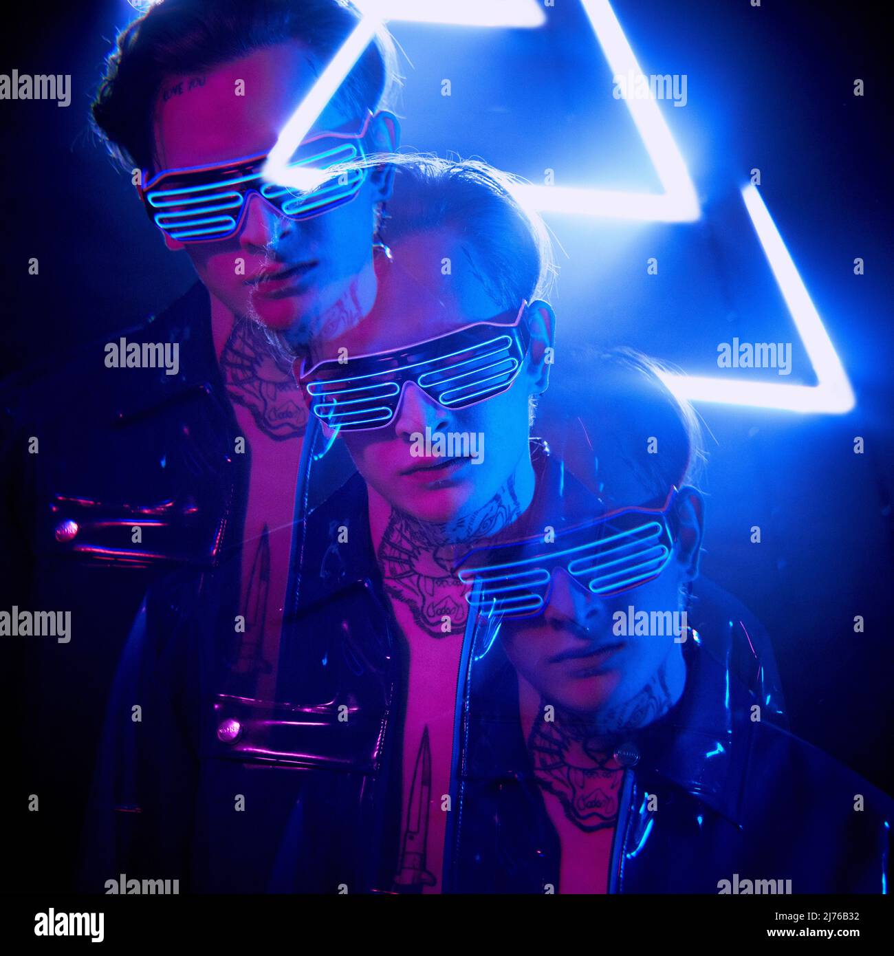 Stroboscopic photo of futuristic young man with tattoo on neck standing ...
