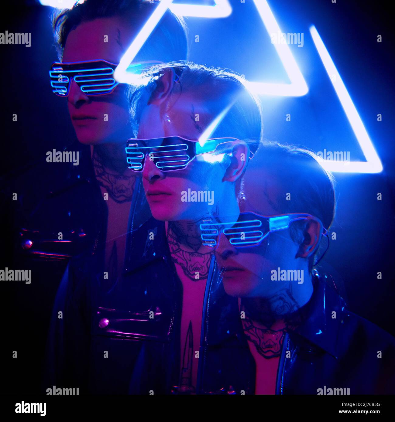 Serious young cyber man in neon goggles reflecting in 3D effect, neon ...