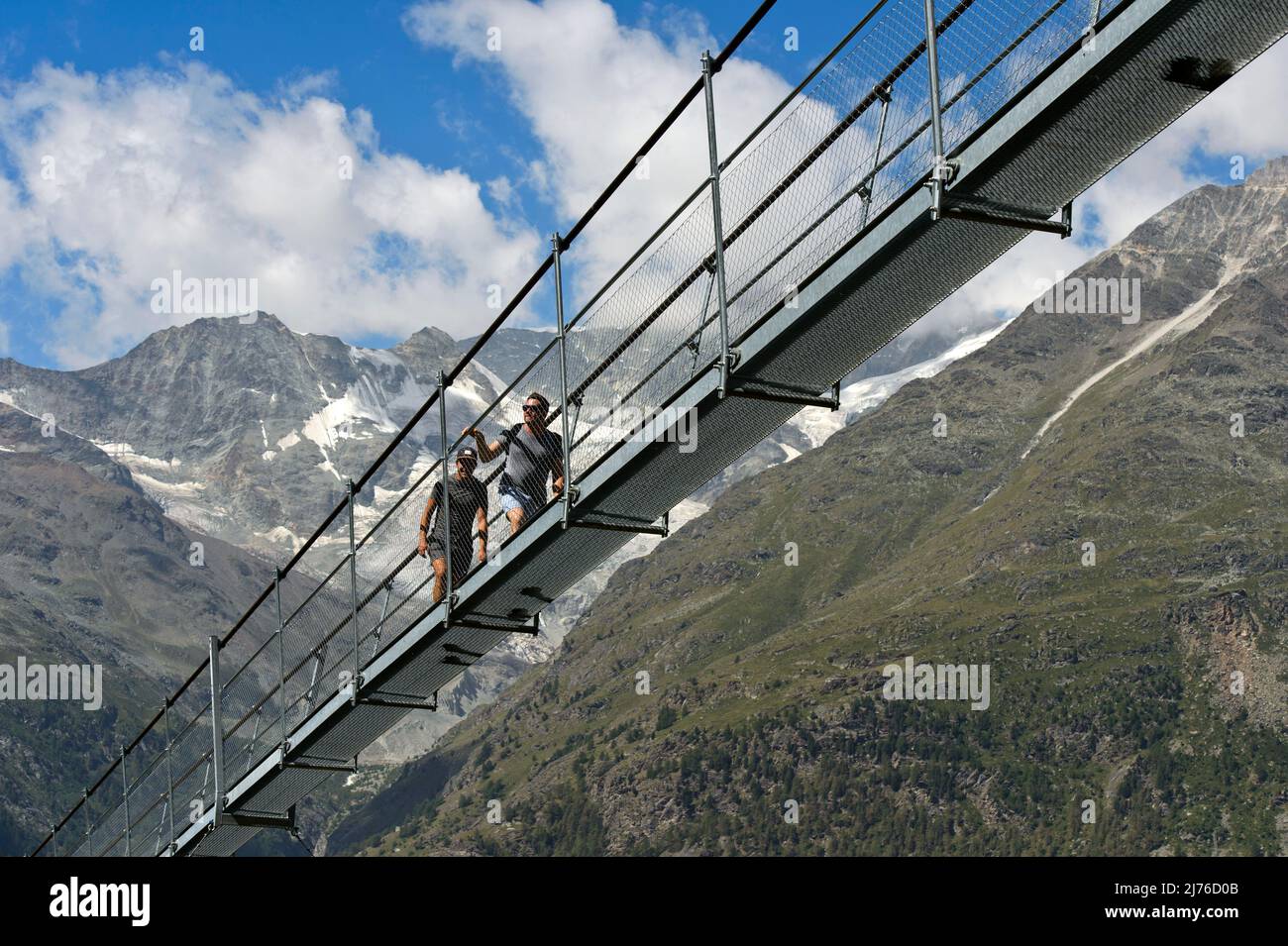 Hiker climbing on charles kuonen suspension bridge hi-res stock ...