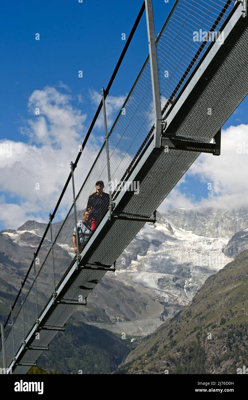 Uphill, hiker climbing on Charles Kuonen suspension bridge, Randa ...