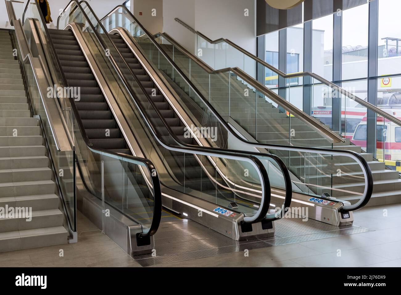 Modern escalator inside at international airport Stock Photo - Alamy