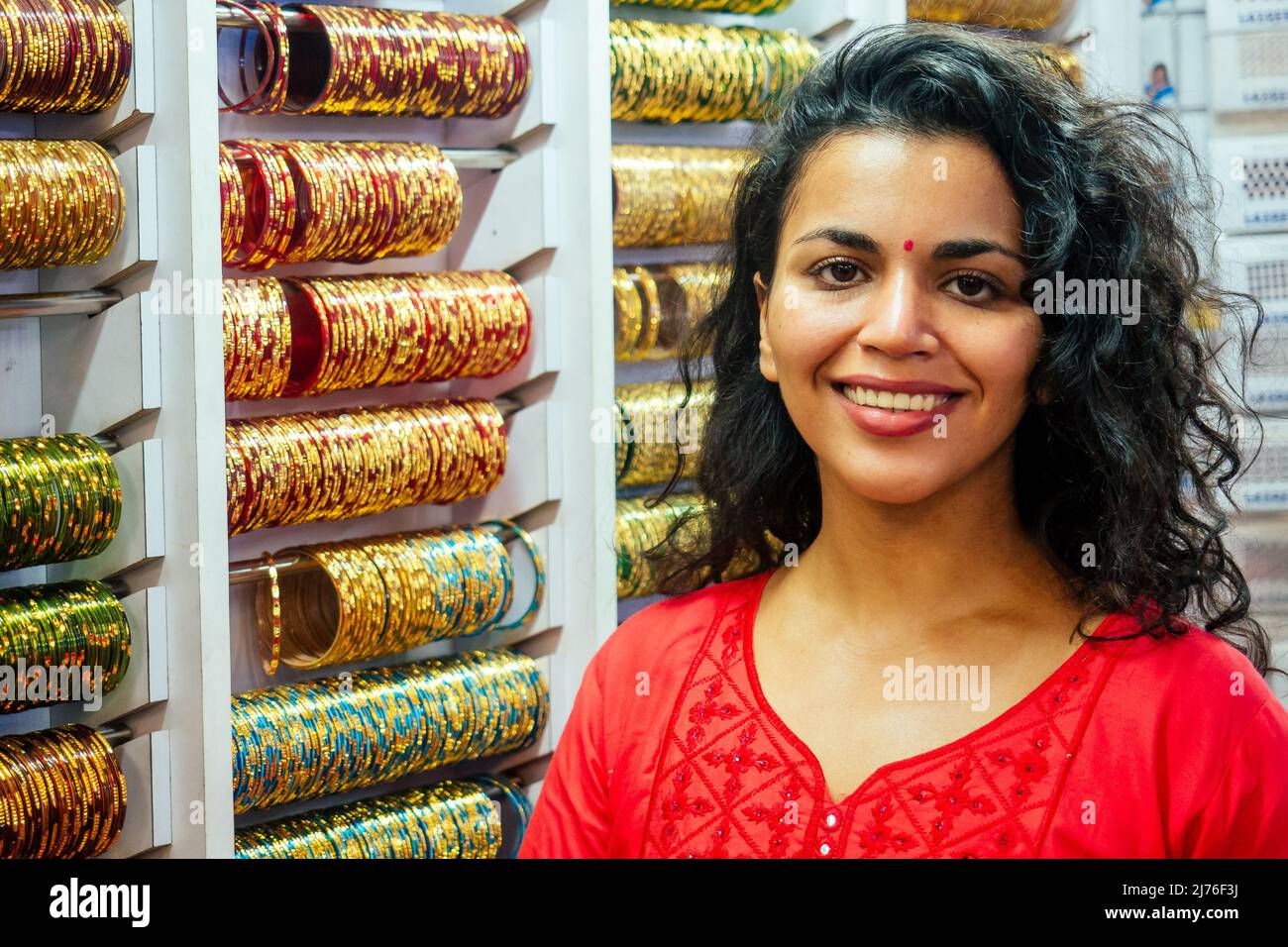 young indian woman show traditional ethnic bracelets in her small ...
