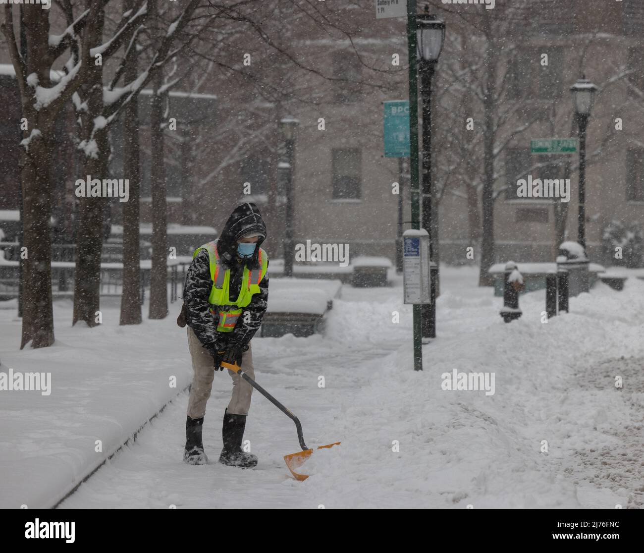 NEW YORK, N.Y. – February 1, 2021: A person shovels snow from a ...
