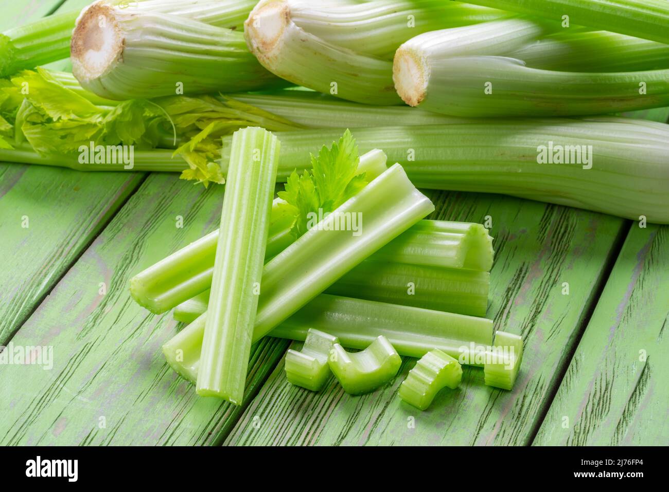Pile of celery ribs on green wooden table. Healthy food background ... Pile of celery ribs on green wooden table. Healthy food background ...