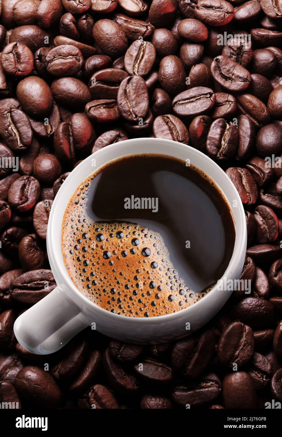 Cup of coffee americano over roasted coffee beans. Top view Stock Photo ...