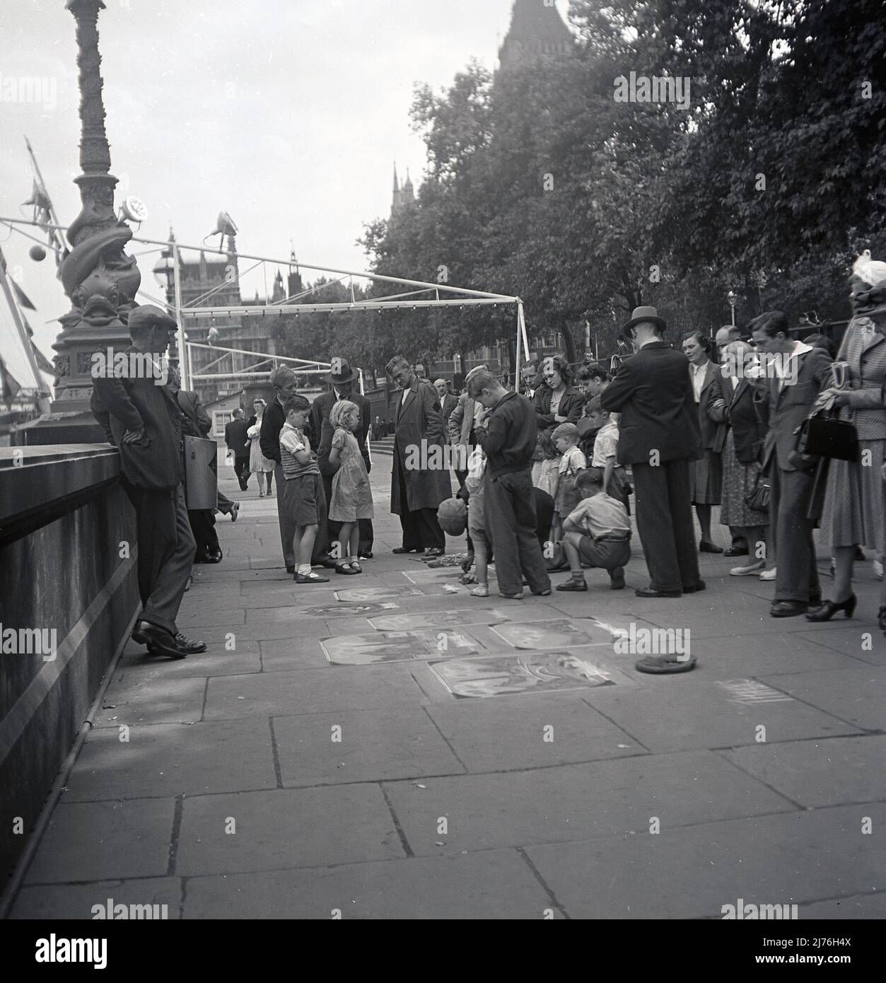 1953, historical, post-war Britain and a small crowd of adults and ...