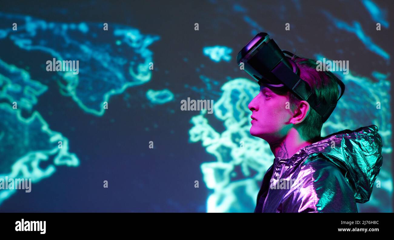 Side view of serious young man with VR goggles on forehead exploring ...