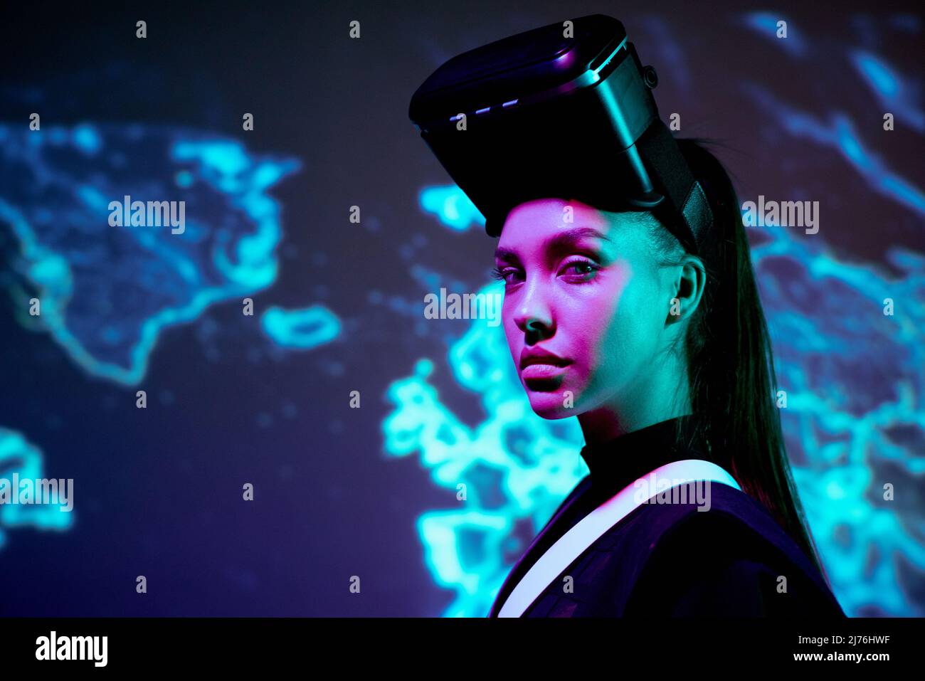 Portrait of serious lady gamer with virtual reality headset standing ...