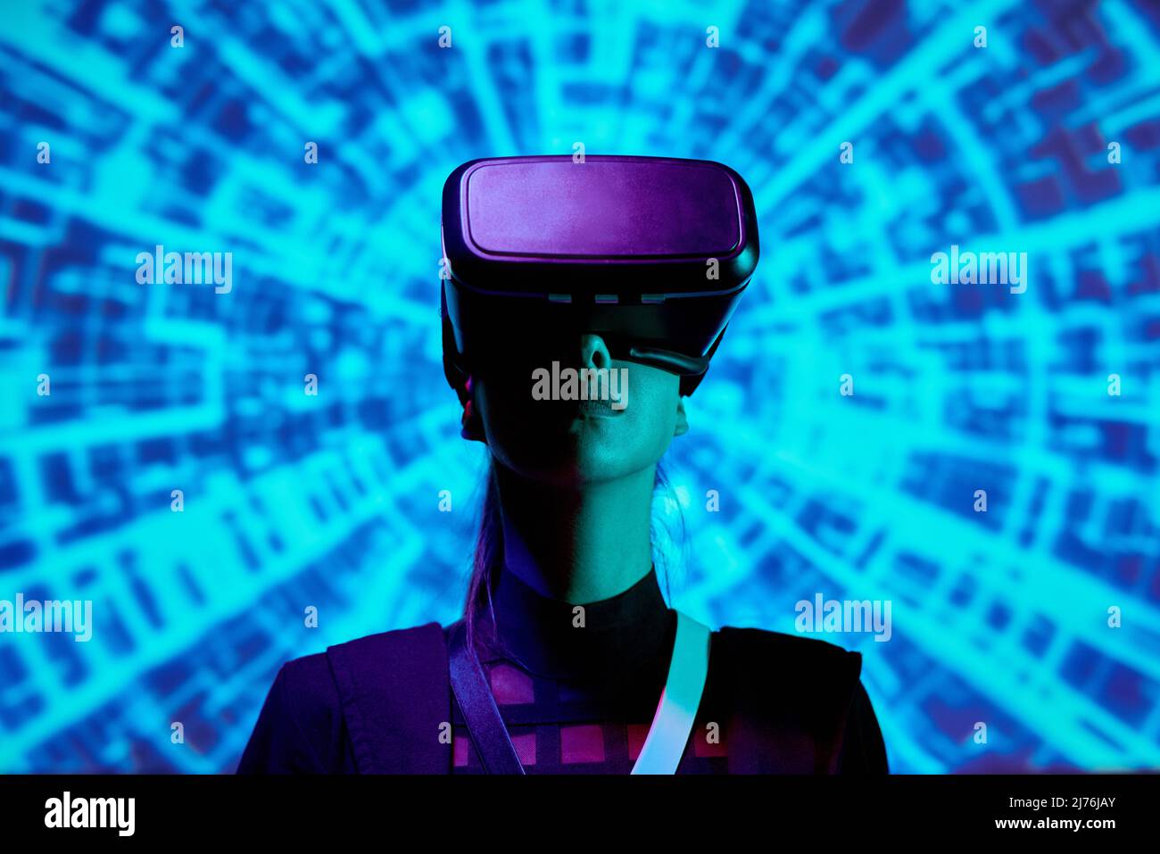 Serious young woman immersed into augmented reality using virtual ...