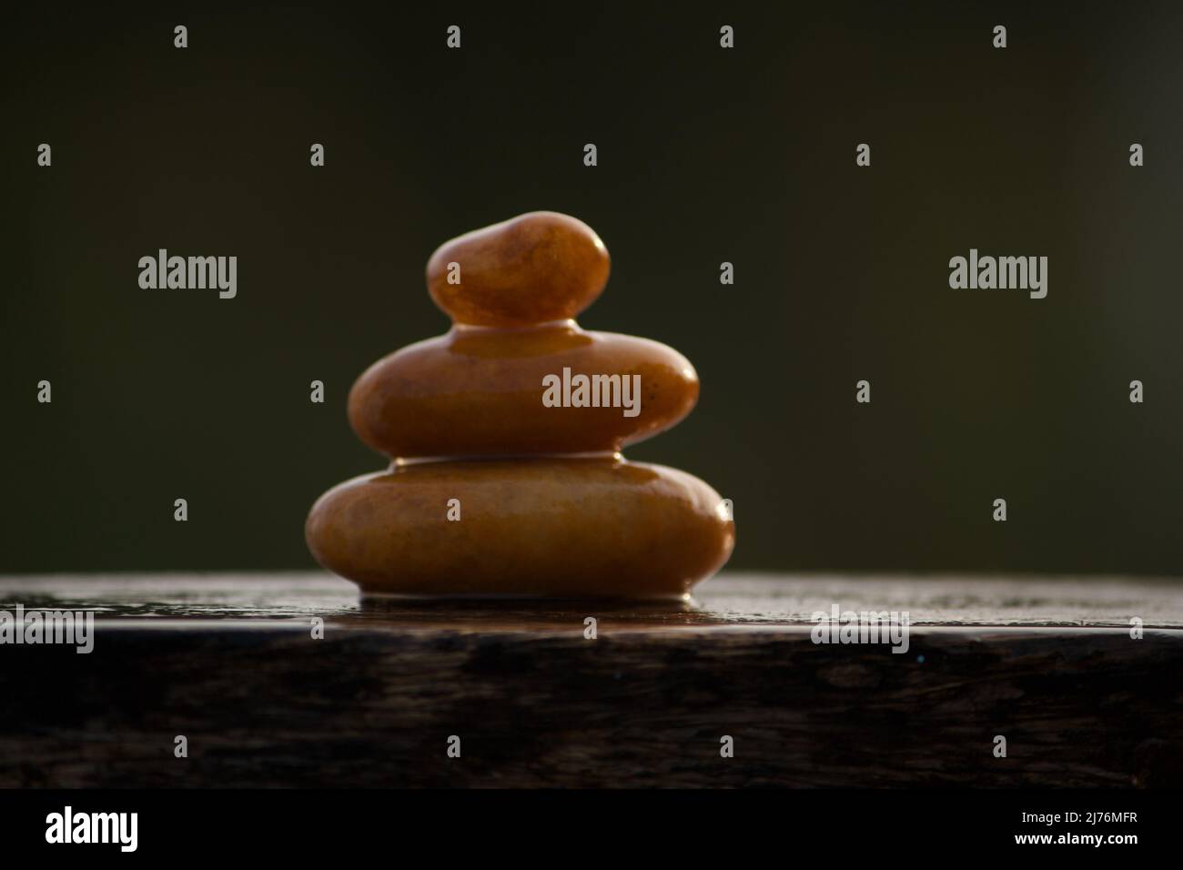 closeup view of quartz stone pebbles balances on a wood plank Stock ...