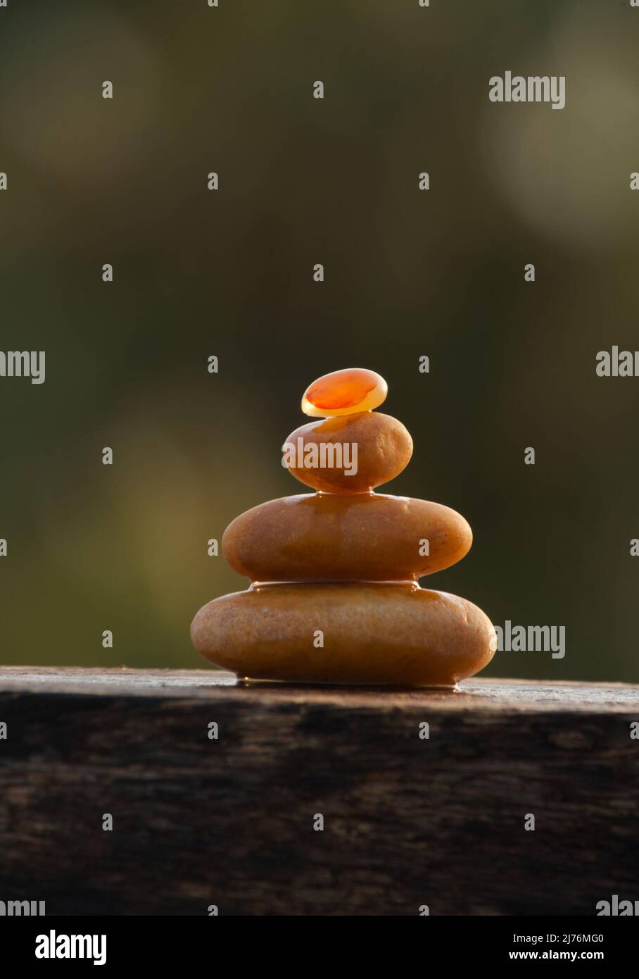 closeup view of quartz stone pebbles balances on a wood plank Stock ...